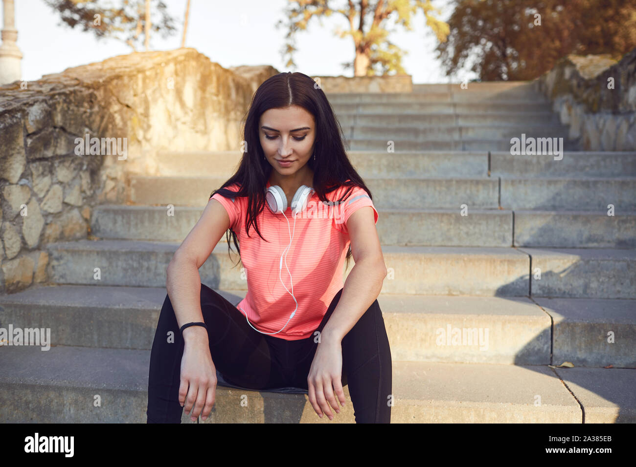 Fitness woman sitting on steps hi-res stock photography and images - Alamy