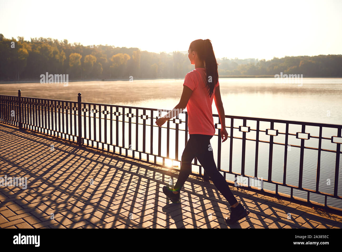 Back view of a runner walking on a road in a park Stock Photo - Alamy