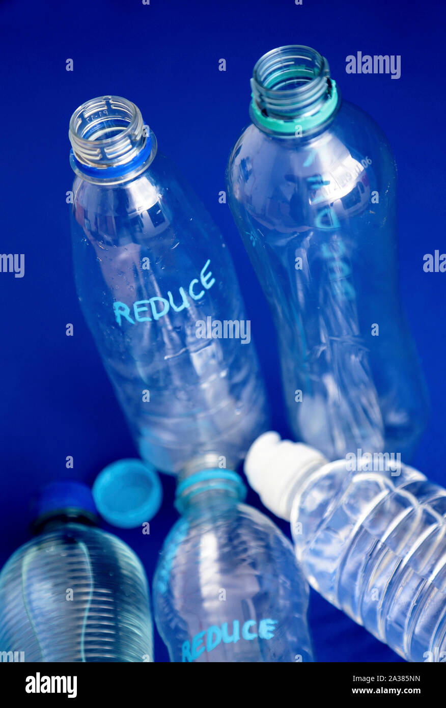 Little plastic bottle with the word reduce (environmental pollution ...