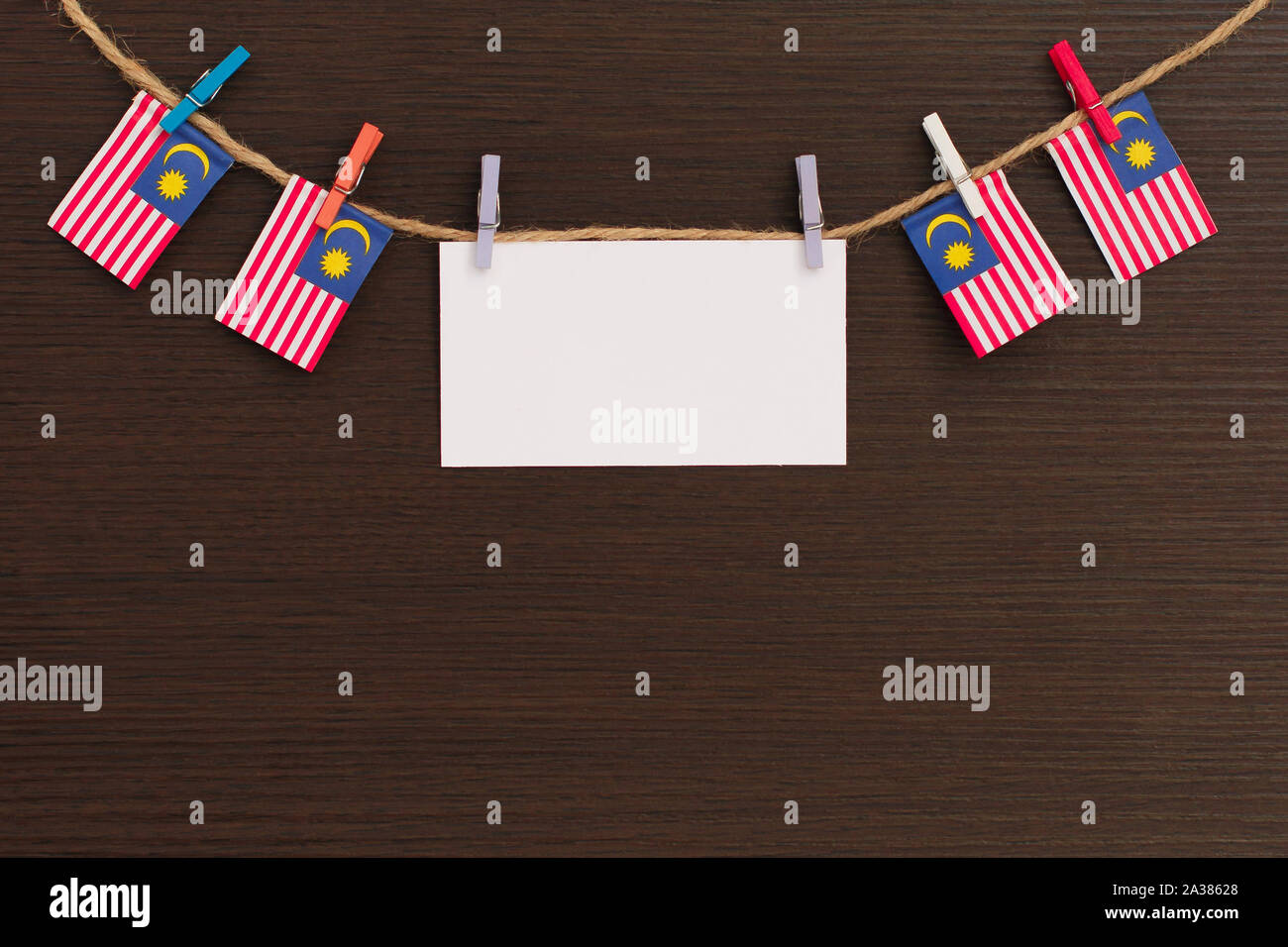Hanging flags of Malaysia attached to rope with clothes pins with copy ...