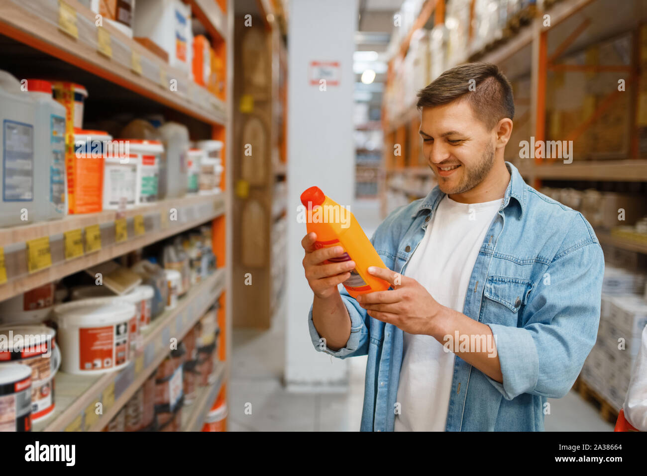 Male consumer choosing materials in hardware store Stock Photo - Alamy