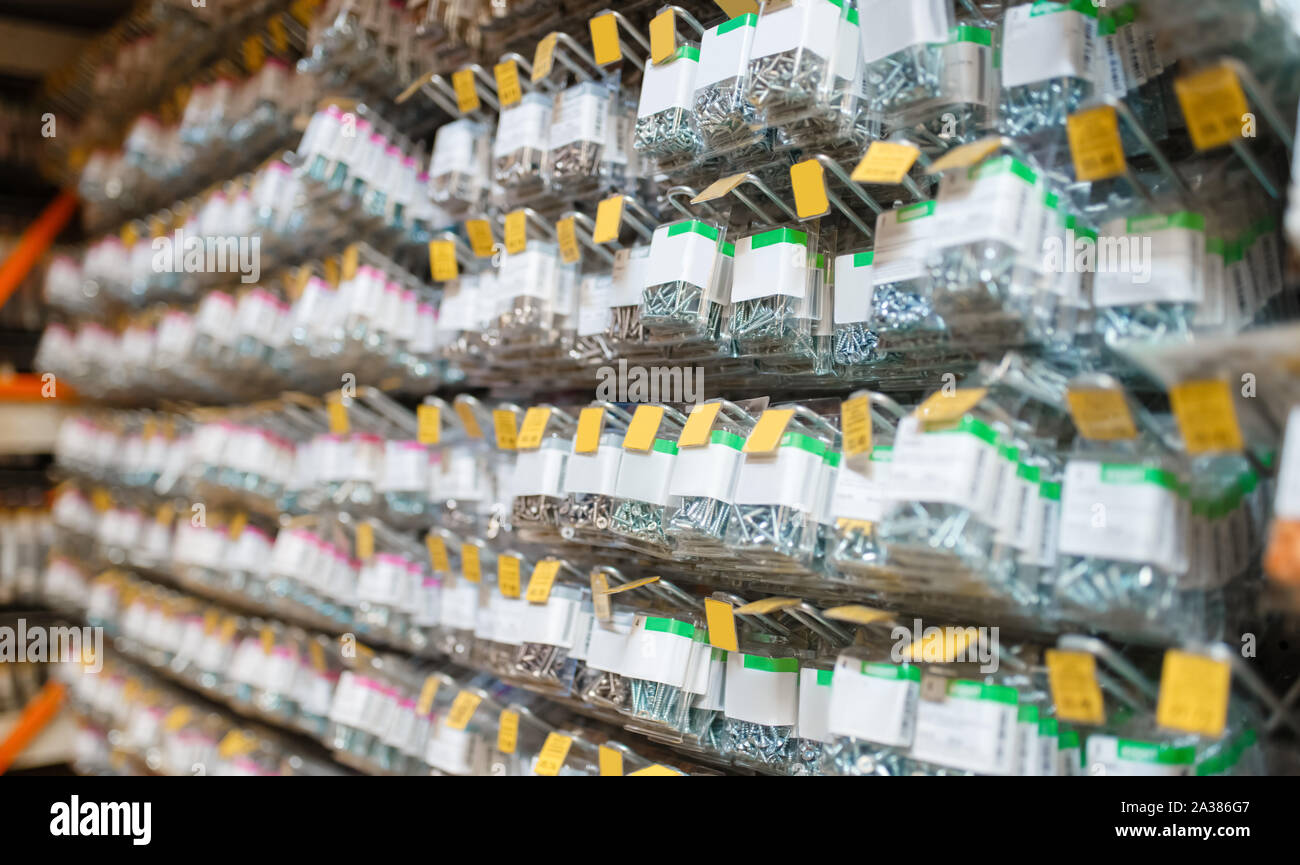 Rows of boxes with bolts in hardware store closeup Stock Photo - Alamy