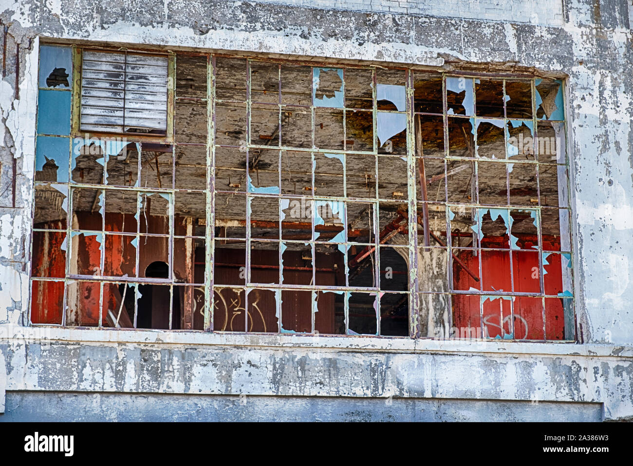 DETROIT, MICHIGAN - APRIL 28, 2019: A window with broken glass provides ...