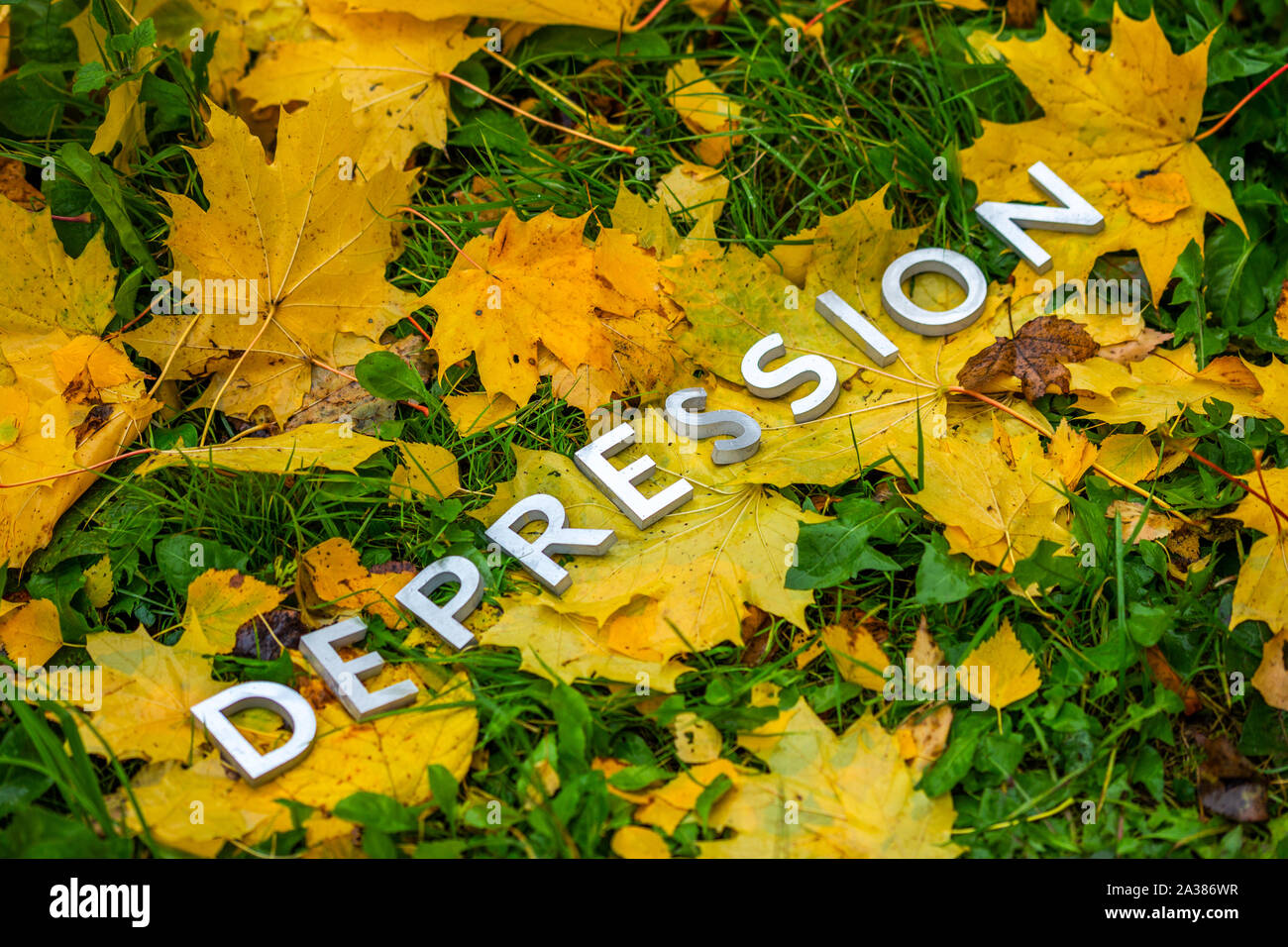 The word DEPRESSION laid with aluminium thick letters on the ground ...