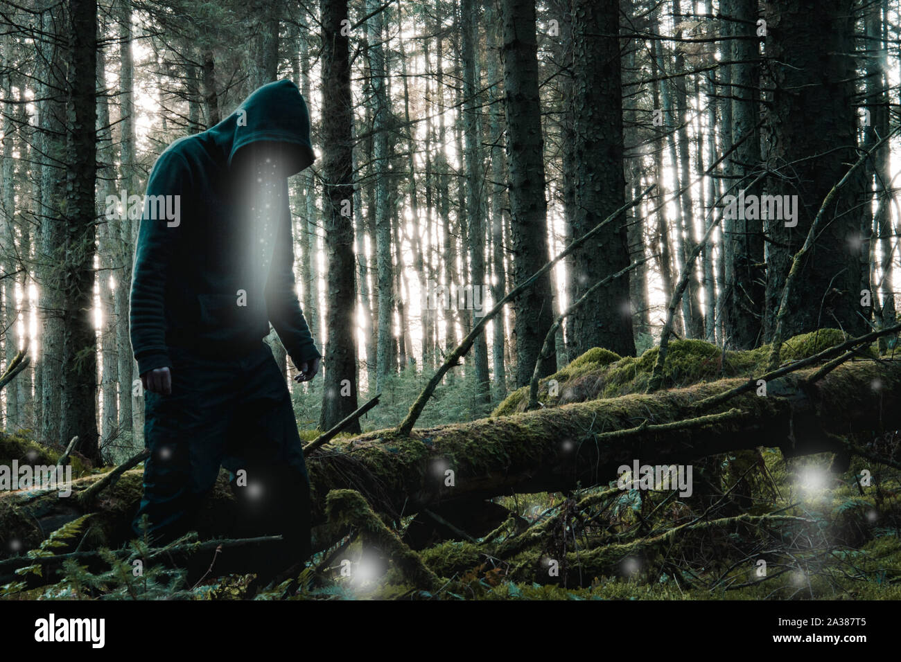 A scary, horror concept. A spooky, hooded figure, looking down as ...