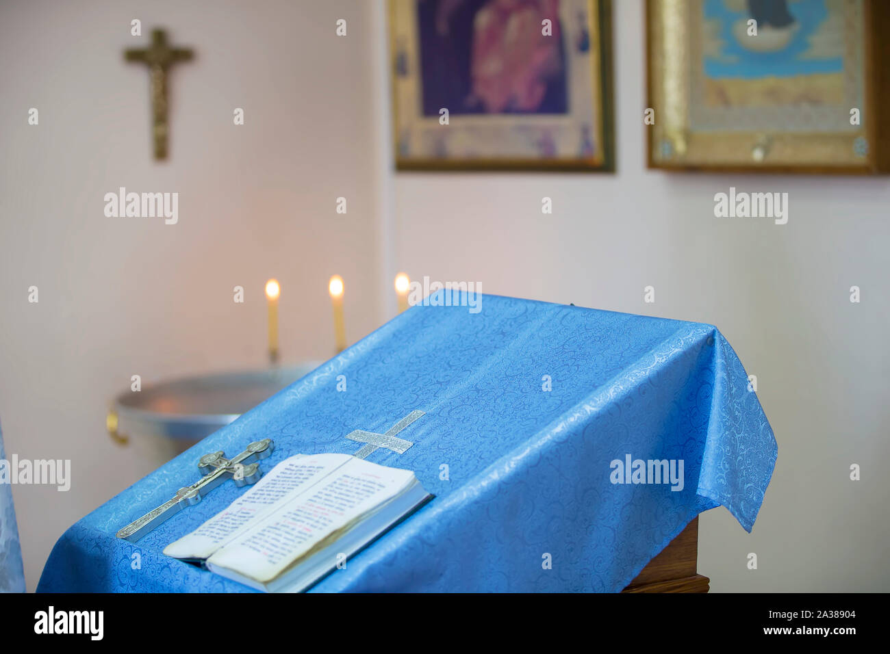 The cross and the book of the Bible lie on the church table. Religion ...