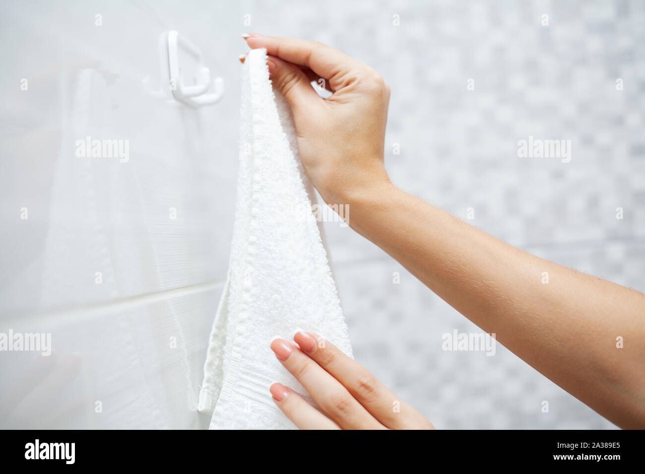Hygiene and hand care. Woman using towel for wiping hands dry after ...