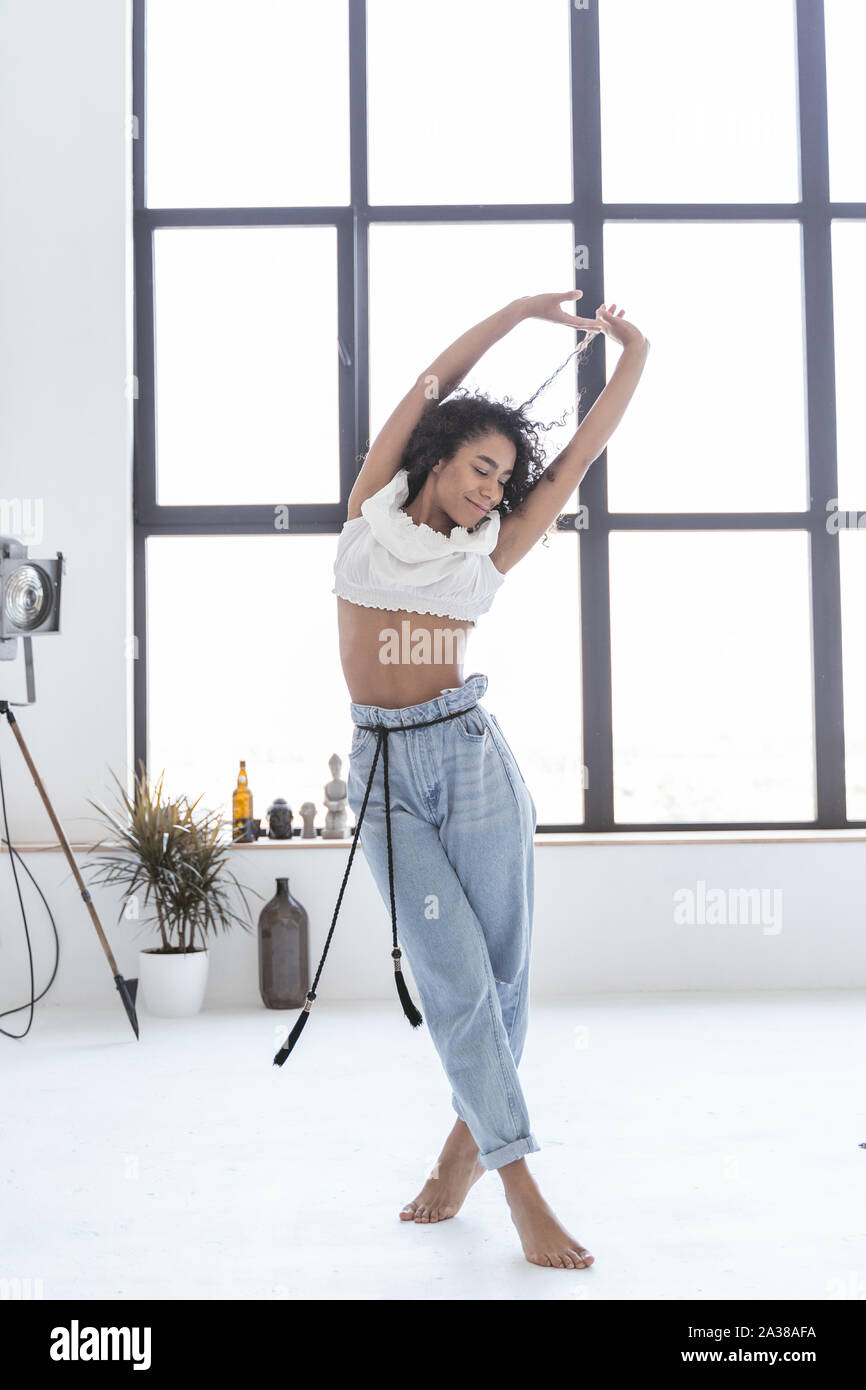 Happy young woman enjoying her dancing alone Stock Photo - Alamy