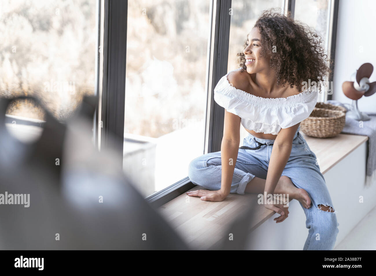 Beautiful woman enjoying the view from her window Stock Photo - Alamy