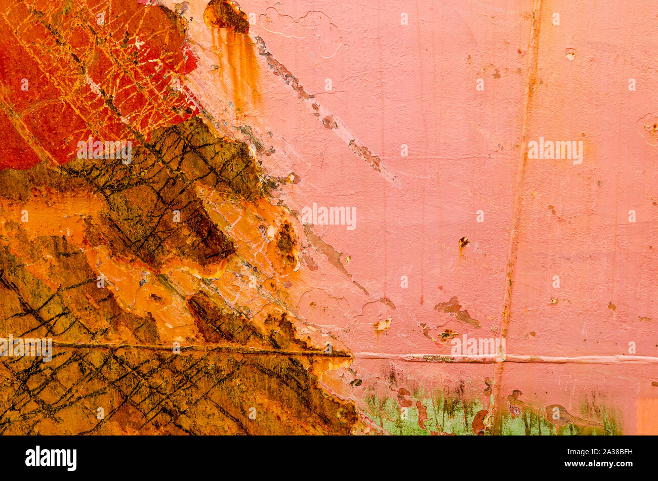 Detail of the weathered hull of a ship, its pink paint replaced by ...