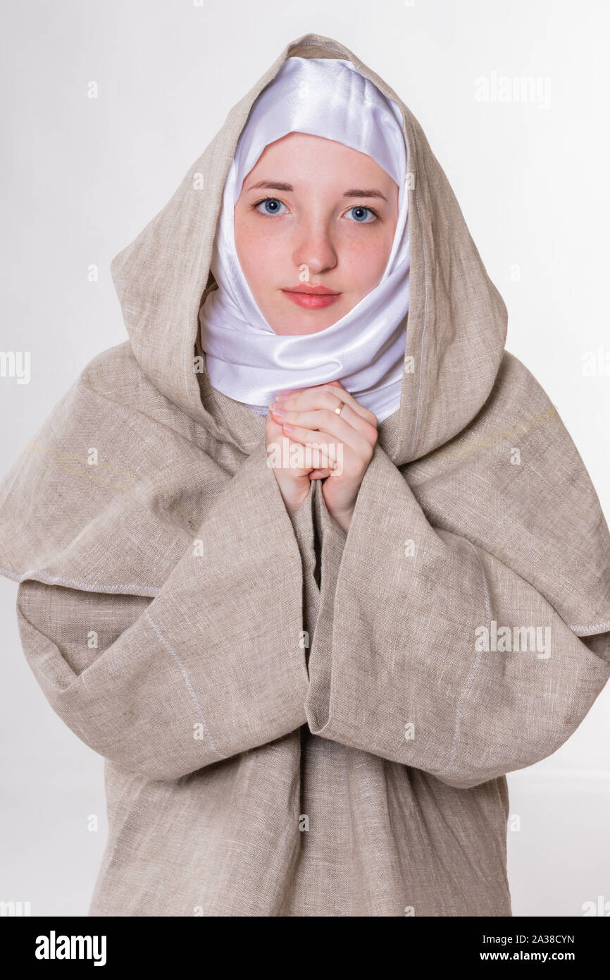 Praying pure girl in monastic clothes and white scarf Stock Photo - Alamy