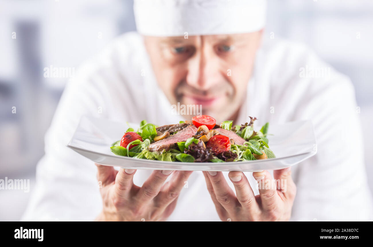 Cook holding plate food in hi-res stock photography and images - Alamy