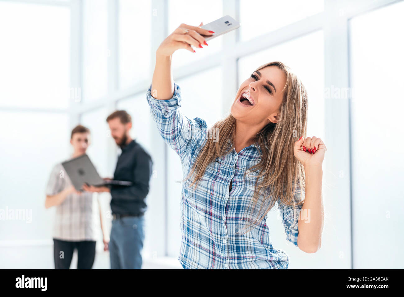 cheerful employee takes a selfie standing in the office Stock Photo - Alamy