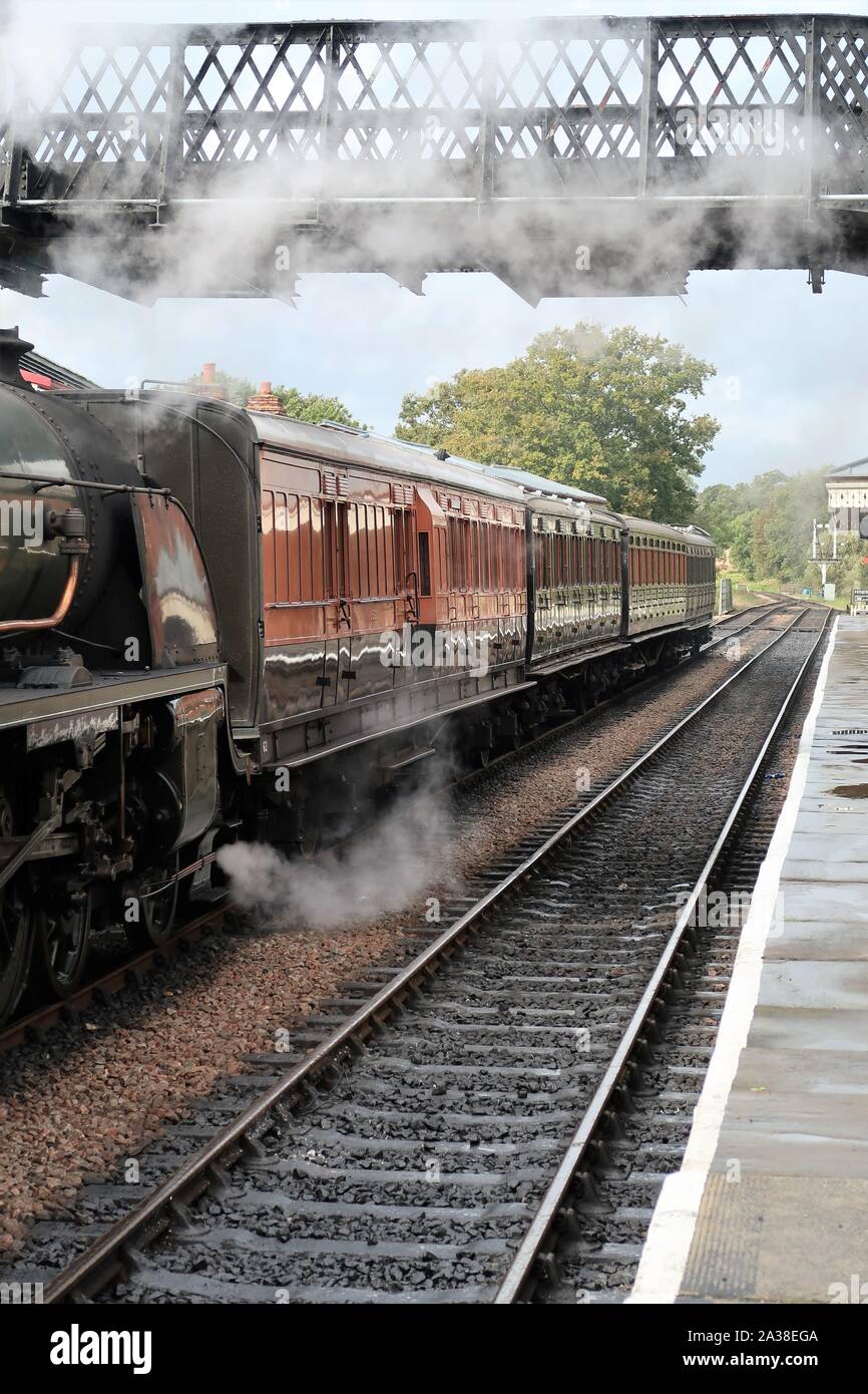 Steam train arrives at platform Stock Photo - Alamy