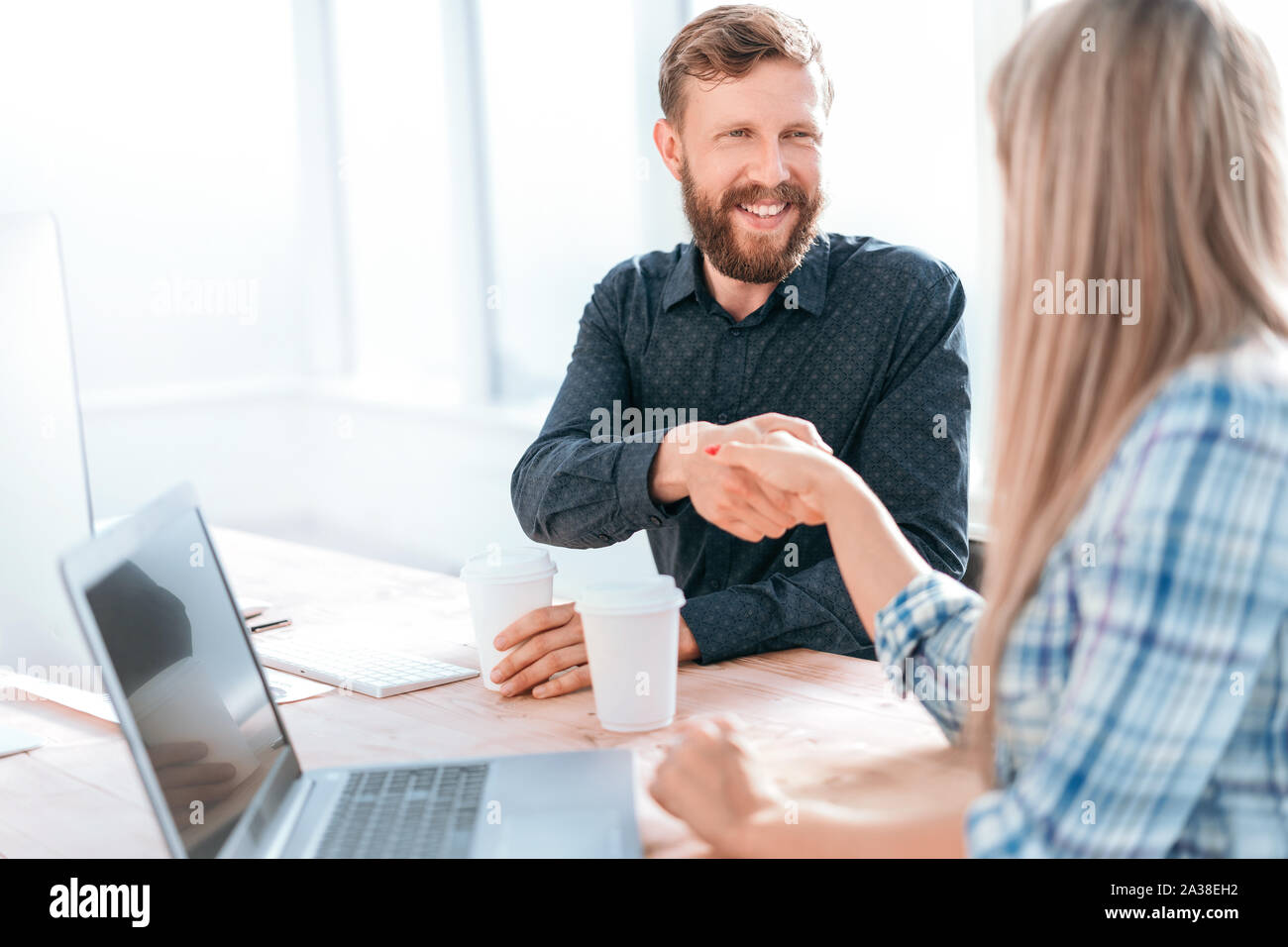Happy colleagues sitting table hi-res stock photography and images - Alamy
