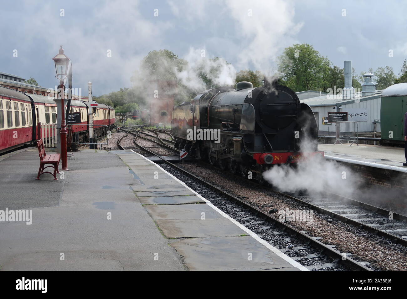 Steam locomotive pulling into station Stock Photo - Alamy