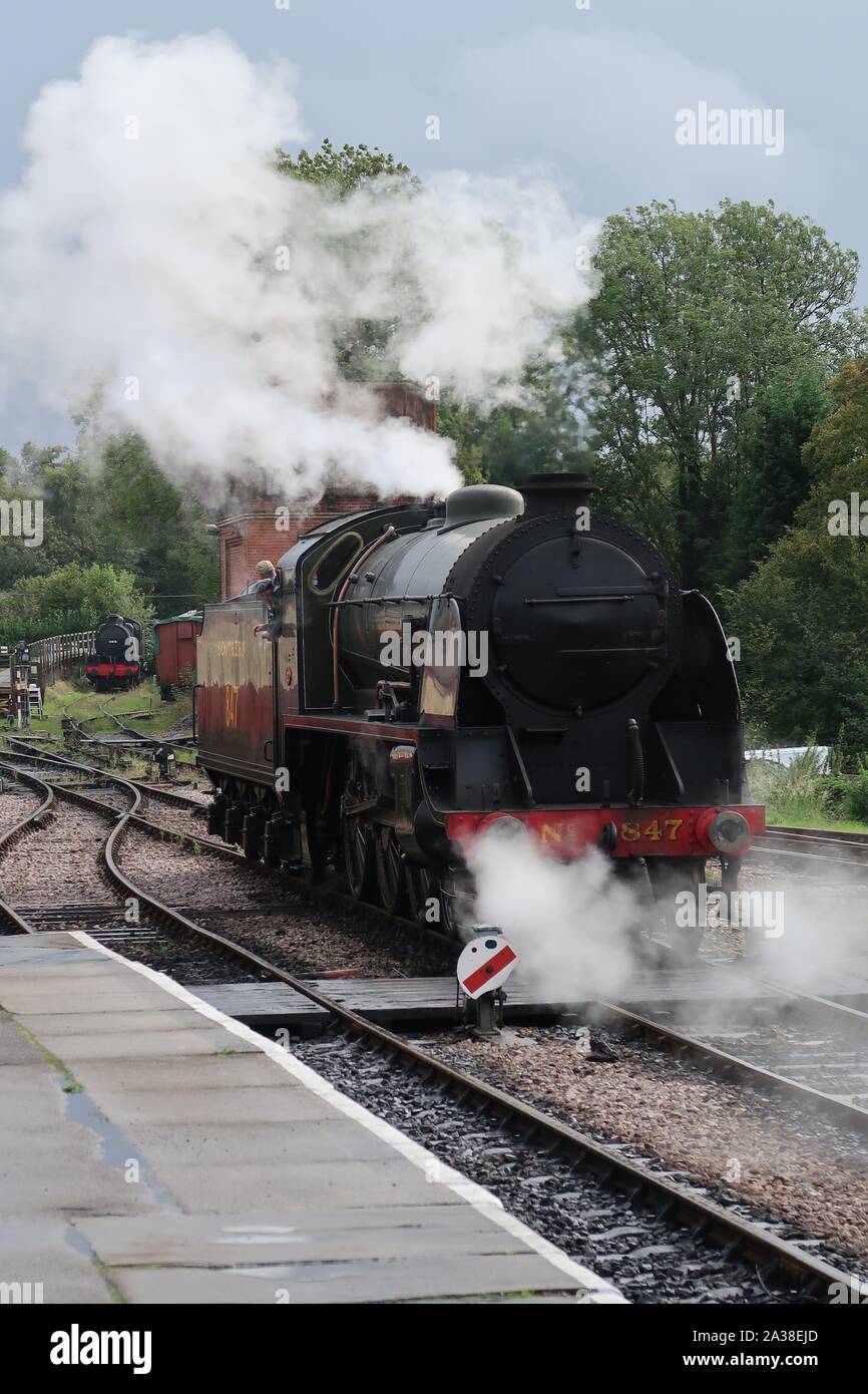 Steam locomotive pulling into station Stock Photo - Alamy