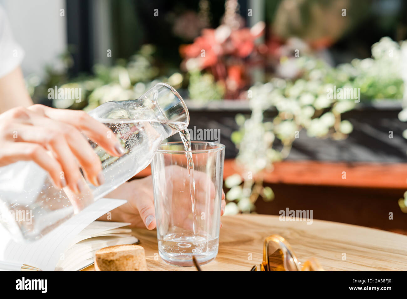 Woman pouring a glass of water Stock Photo - Alamy