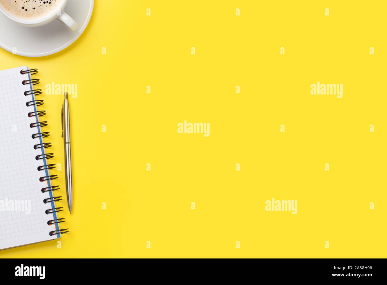 Office yellow workplace backdrop with coffee cup and supplies. Flat lay ...