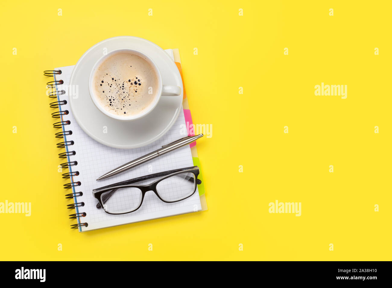 Office yellow workplace backdrop with coffee cup and supplies. Flat lay ...