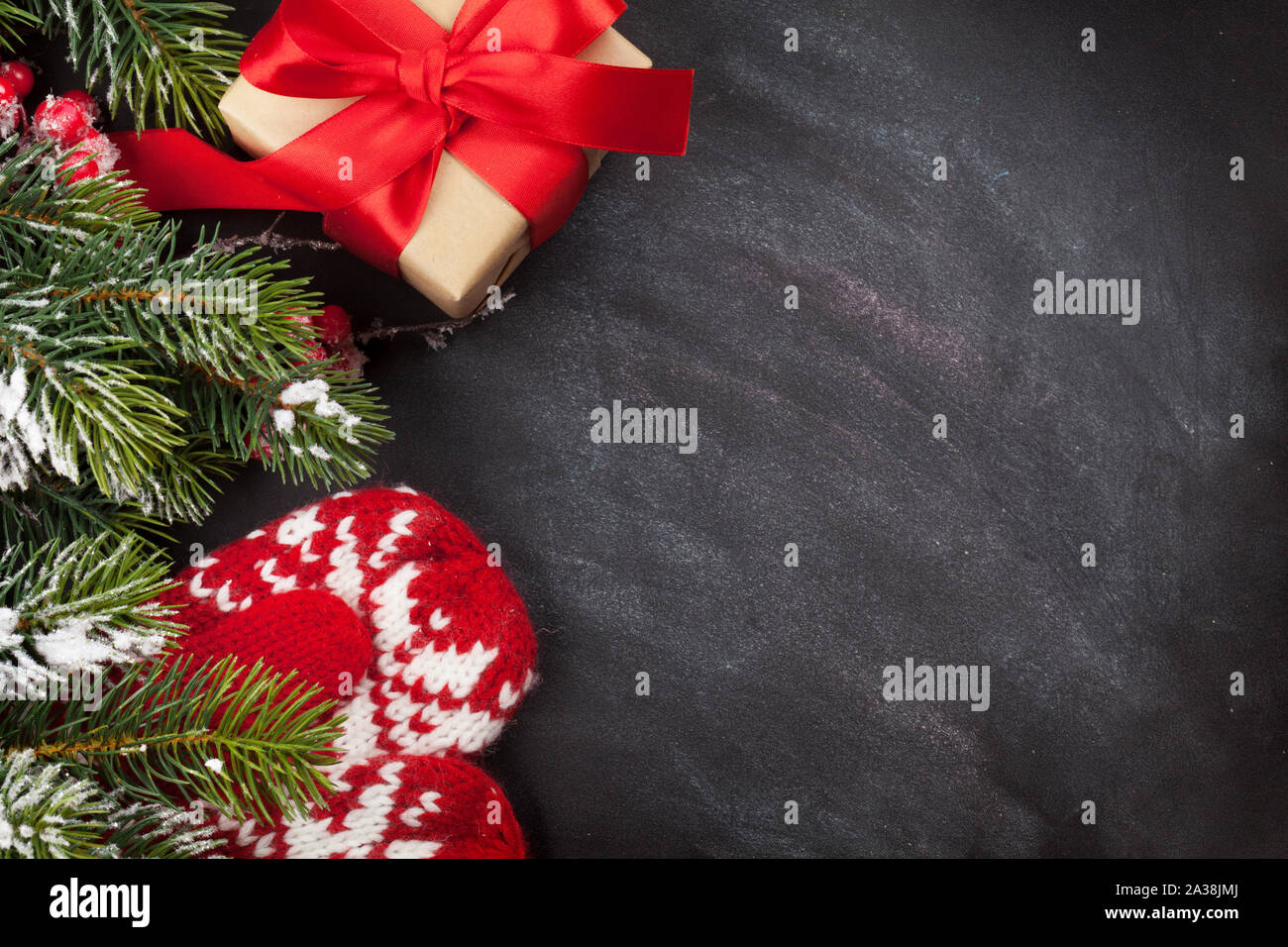 Christmas greeting card with gift box and fir tree branch over ...