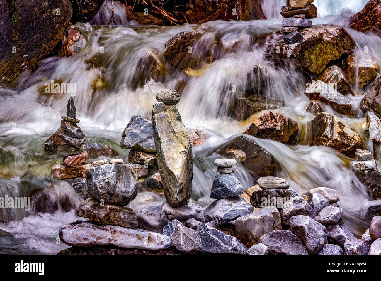 Fast flowing rapids against rocks and cairns Stock Photo - Alamy
