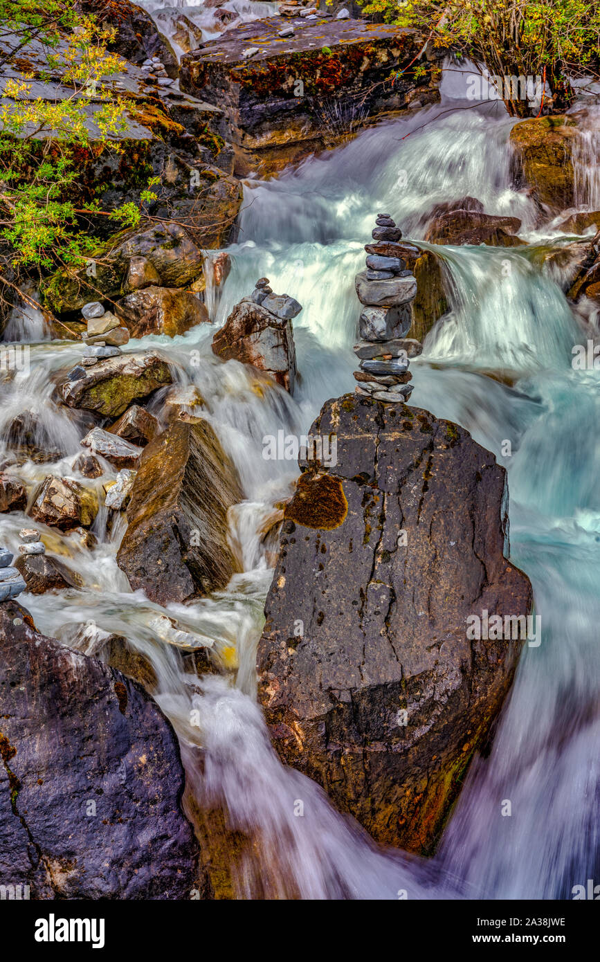 Fast flowing rapids against rocks and cairns Stock Photo - Alamy