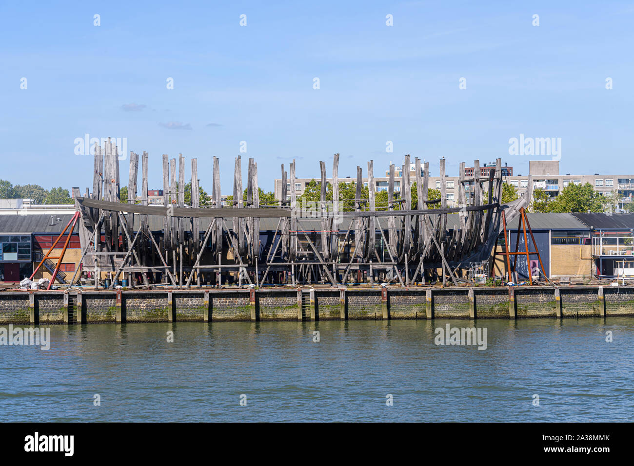 The wooden hull of a tall ship under construction at the Port of ...