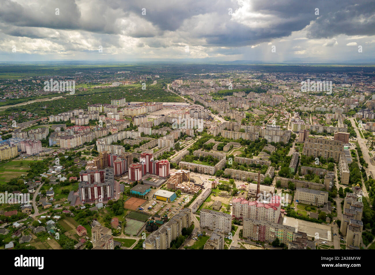 Aerial view of town or city with rows of buildings and curvy streets in ...