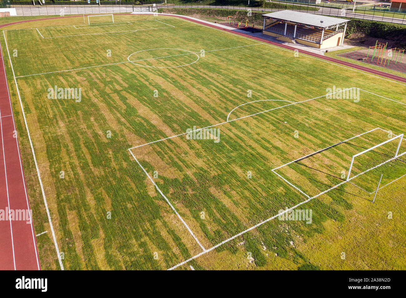 Aerial view of a football field on a stadium covered with green grass ...
