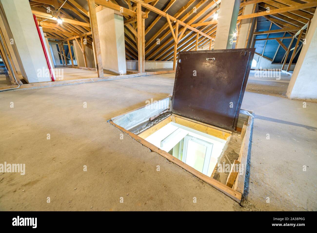 Attic of a building with wooden beams of a roof structure and a fire ...
