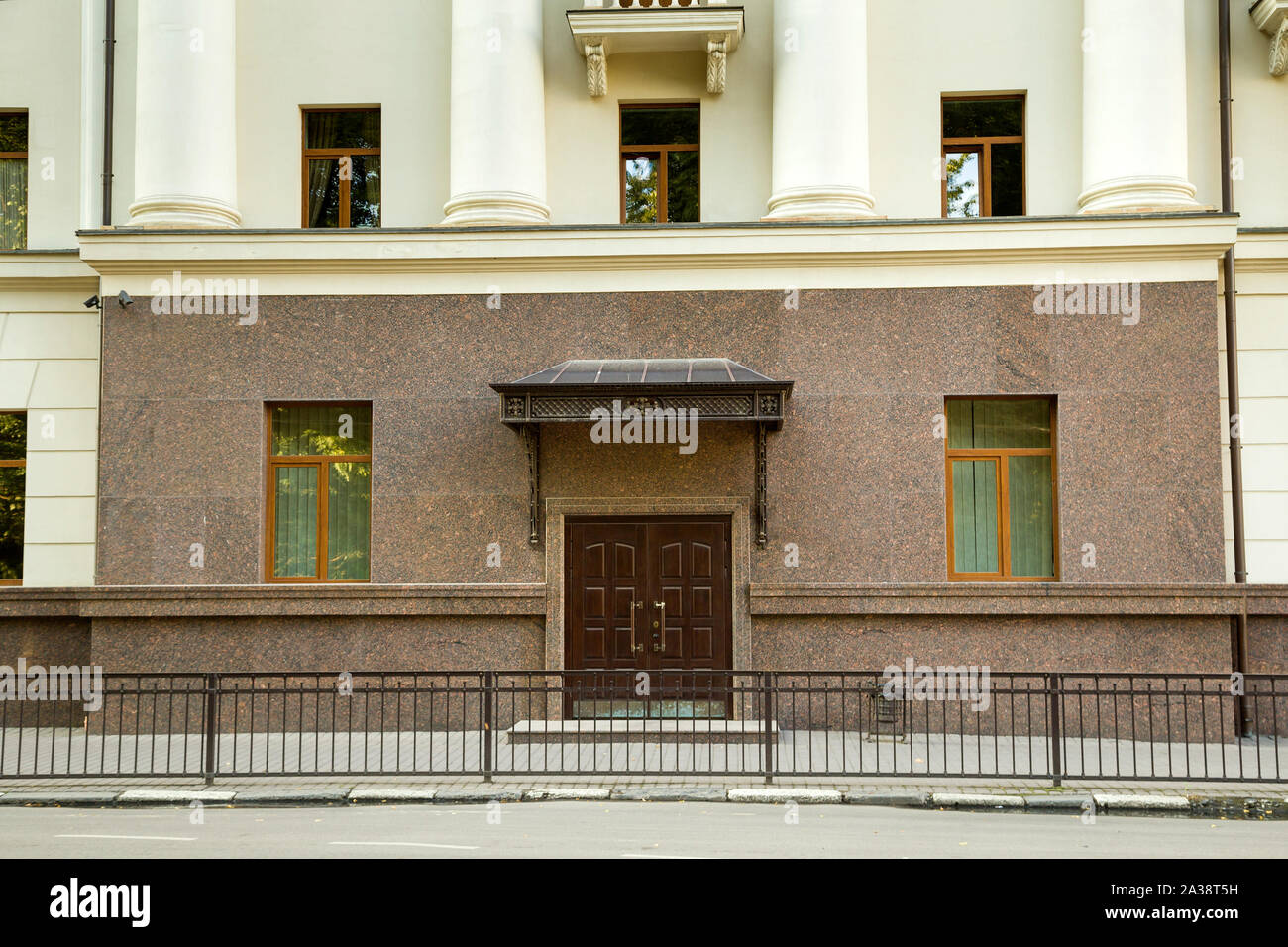 Part of a building facade with the surface of granite wall. Natural ...
