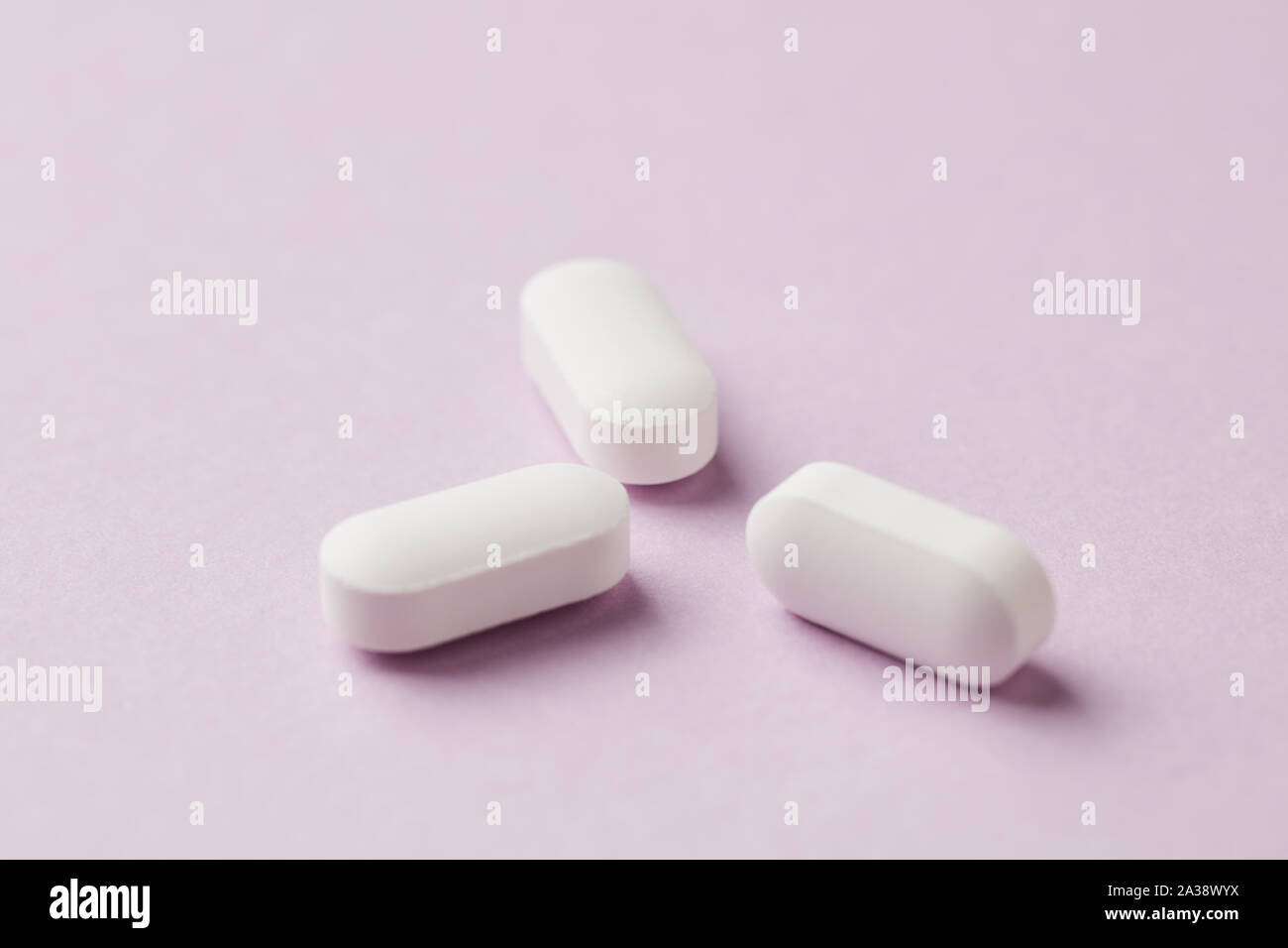 Magnesium with Vitamin B6 Tablets on pink paper background. Dietary ...