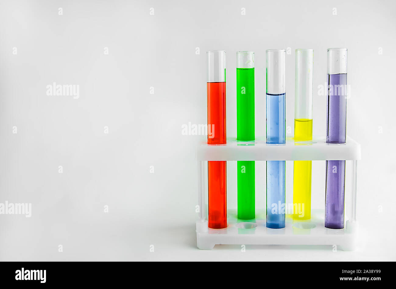 test tubes with multi-colored reagents on a white background. chemistry ...