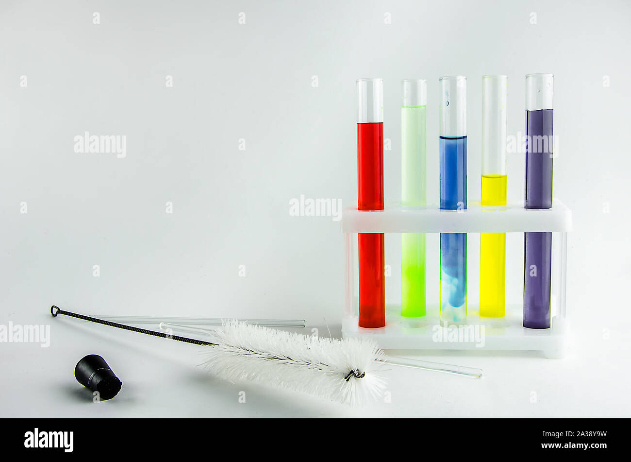 test tubes with multi-colored reagents on a white background. chemistry ...