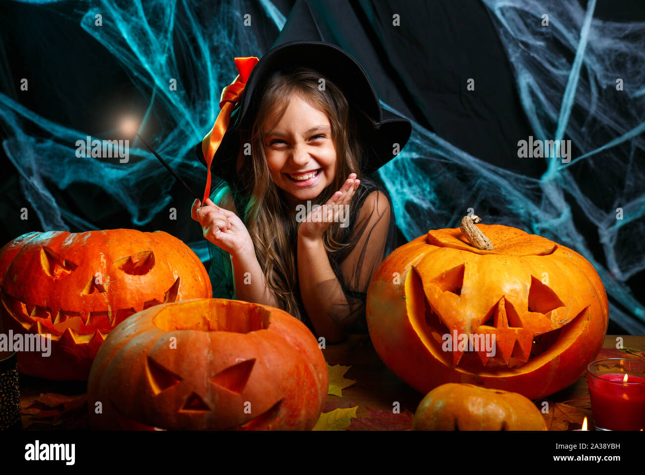 little witch child enjoy playing with magic wand over spider web and ...