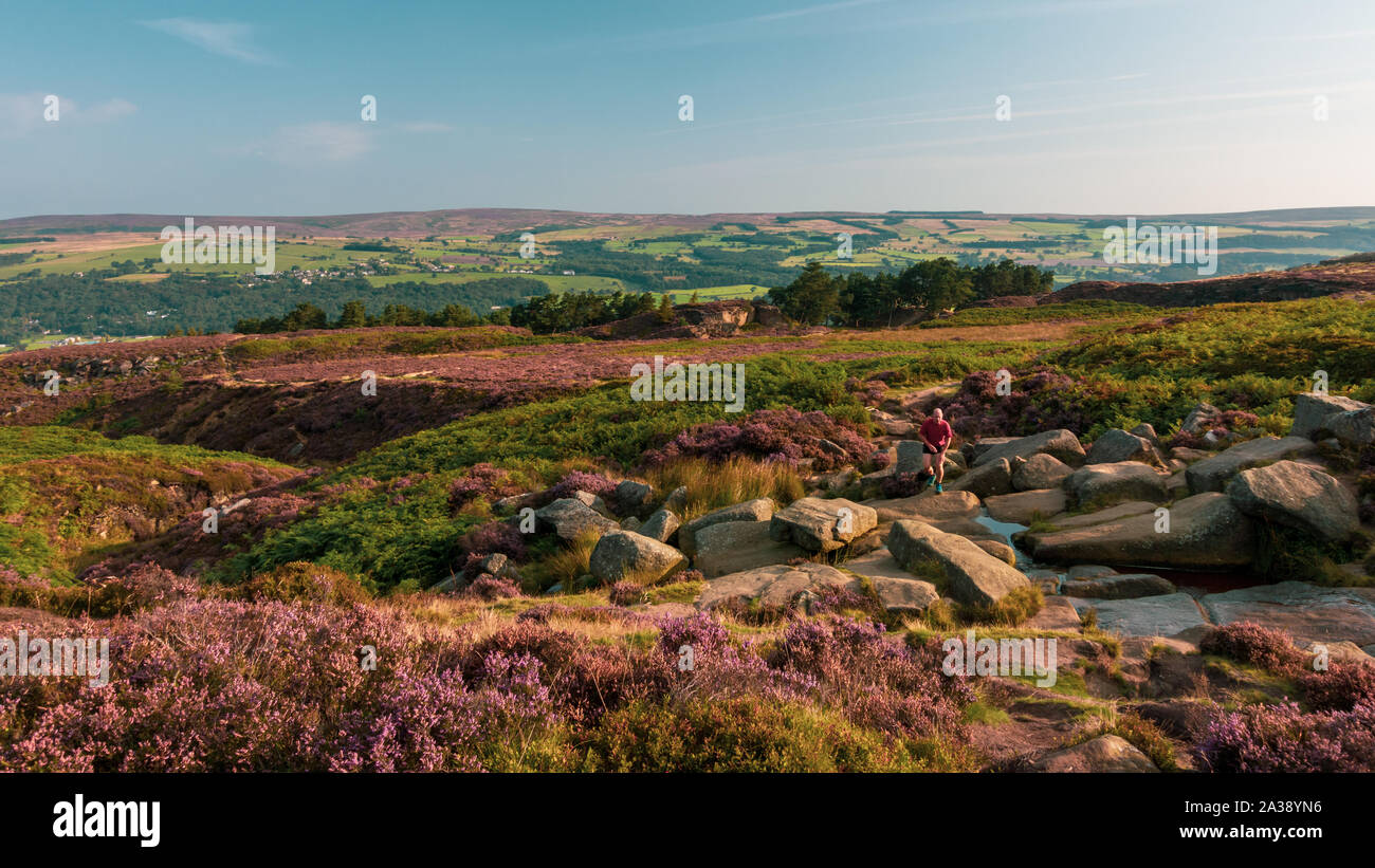 man fell running on Ilkley moor countryside heading up to Rocky Valley ...