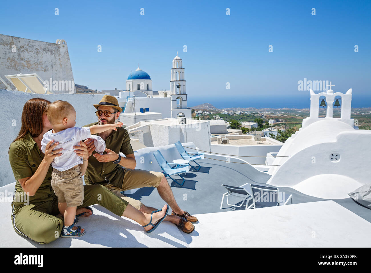 Family with a child travel around the island of Santorini, Greece Stock ...