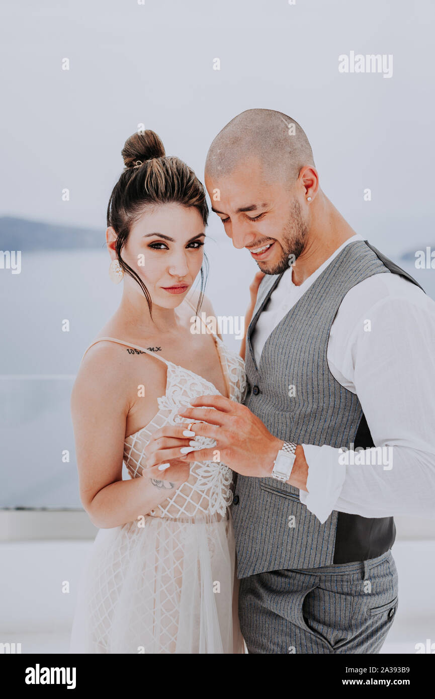 beautiful bride and groom in their summer wedding day on greek island ...