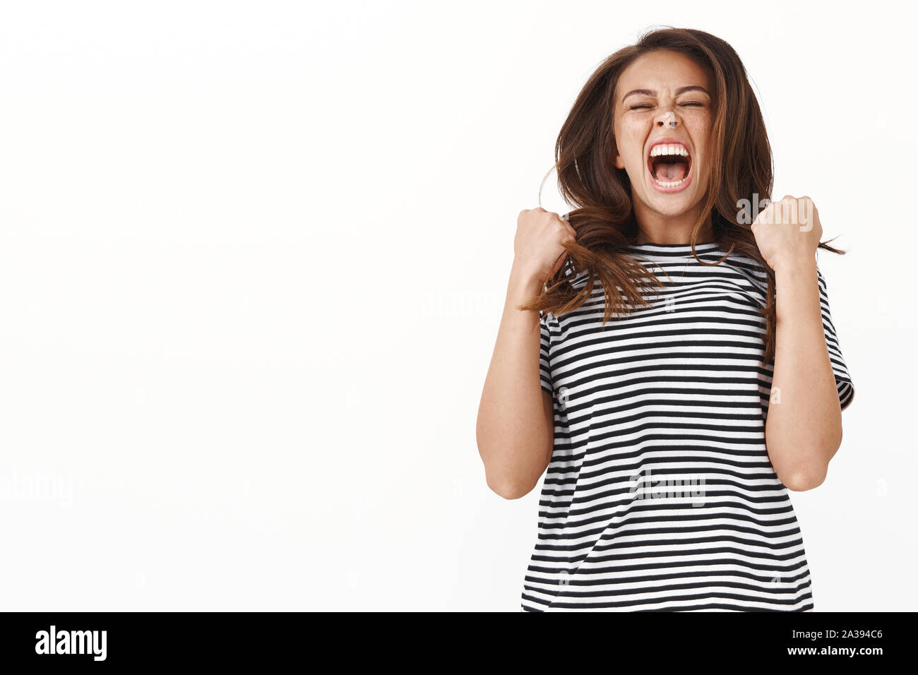 Empowered happy triumphing woman, jumping from happiness and delighted ...