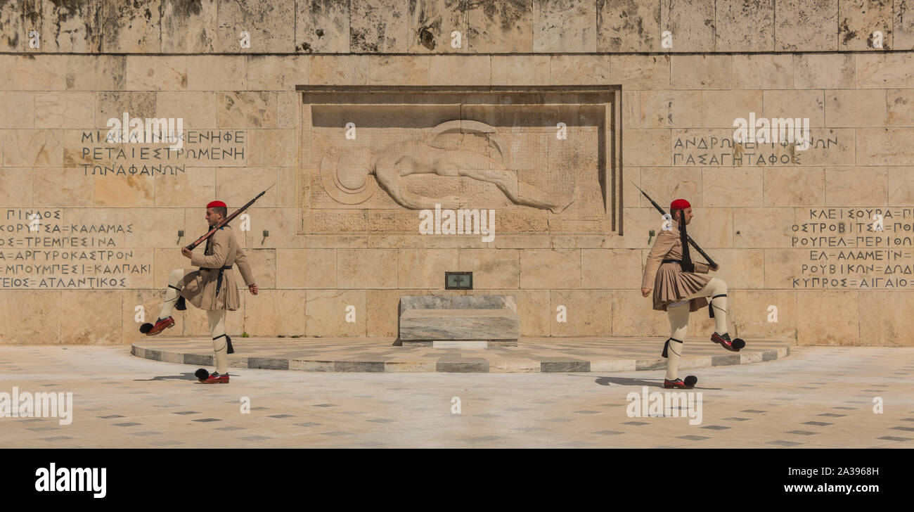 A picture of two guards doing a routine in front of the Hellenic ...