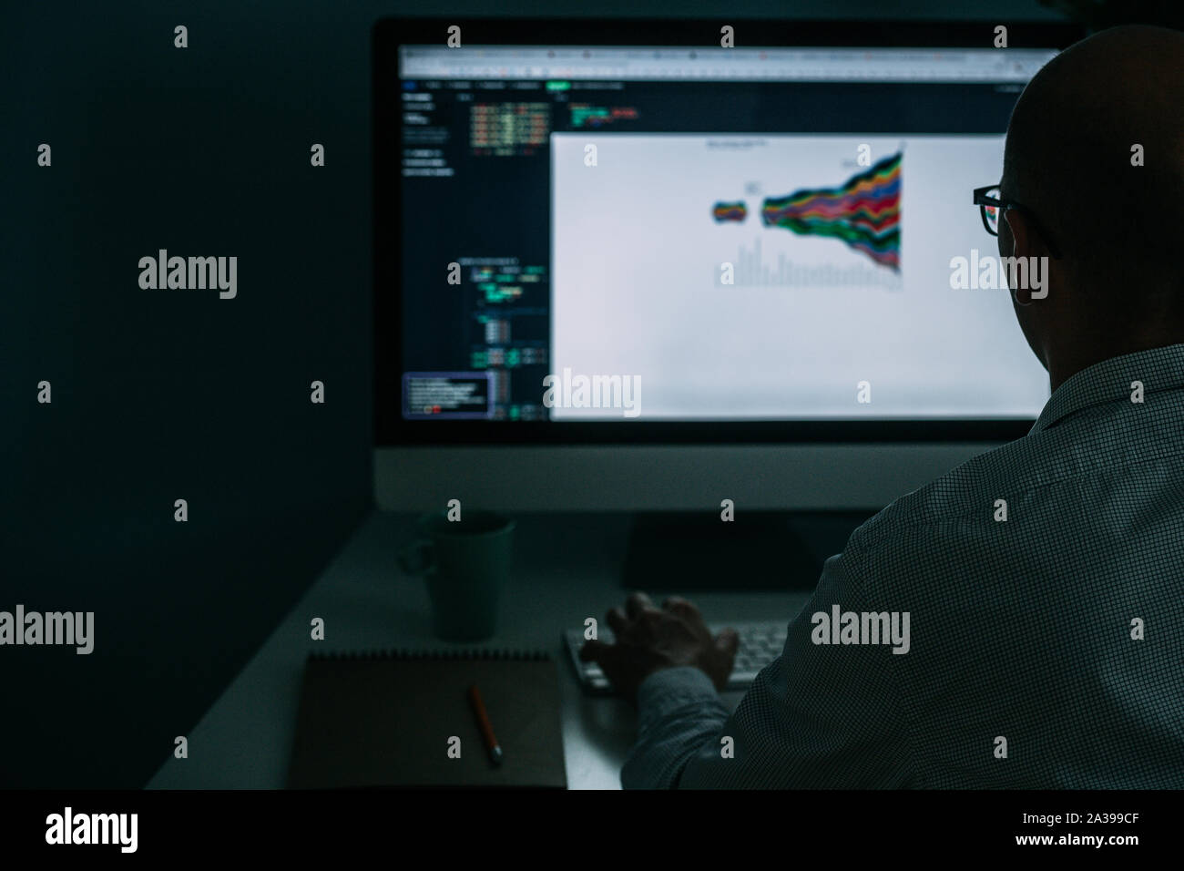 Developer, working behind the desk, analysing diagram on the monitor ...