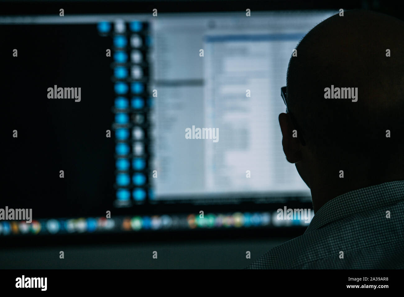 Developer, working behind the desk, analysing diagram on the monitor ...