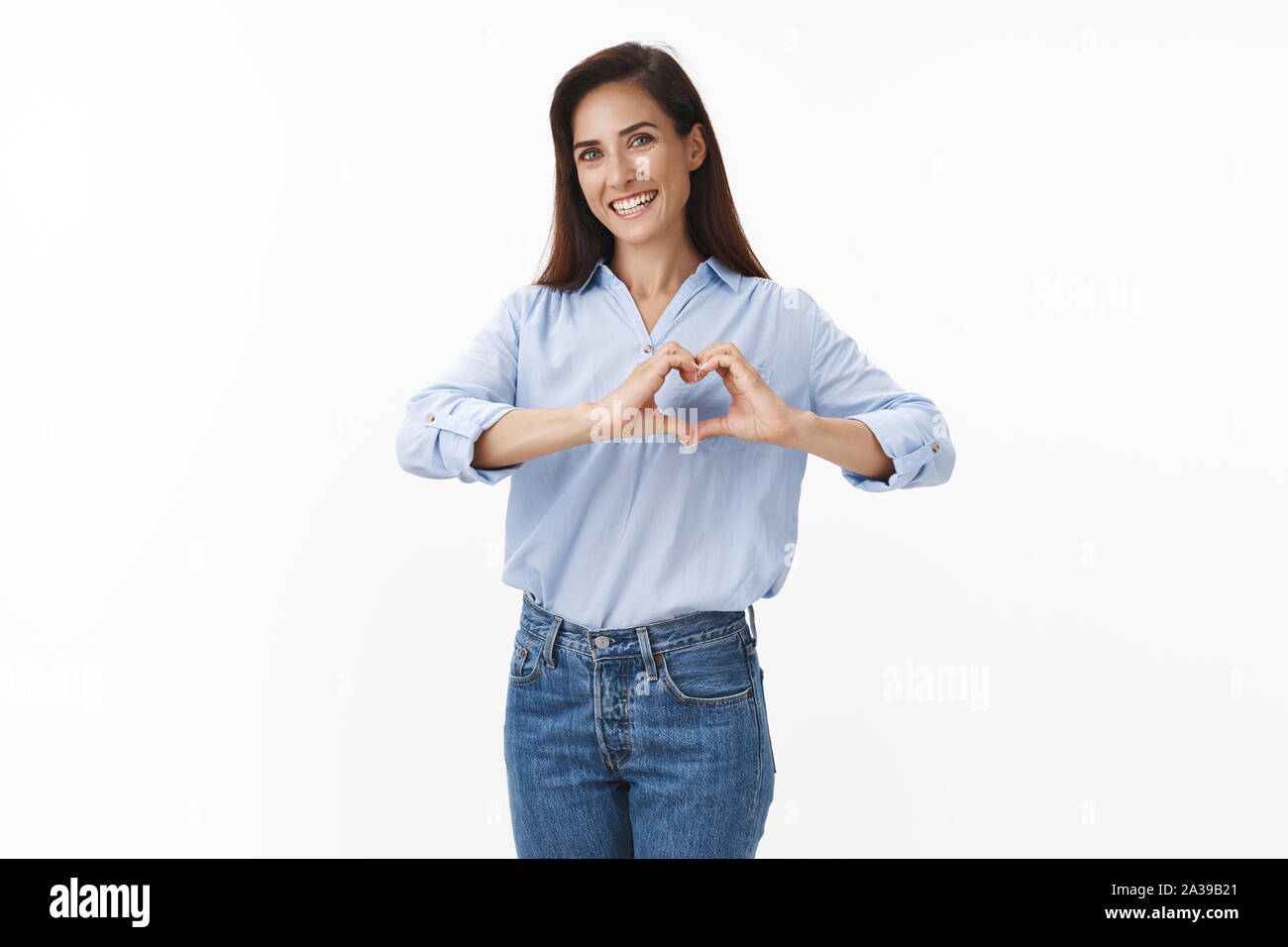 Positive healthy happy middle-aged woman show heart sign smiling ...