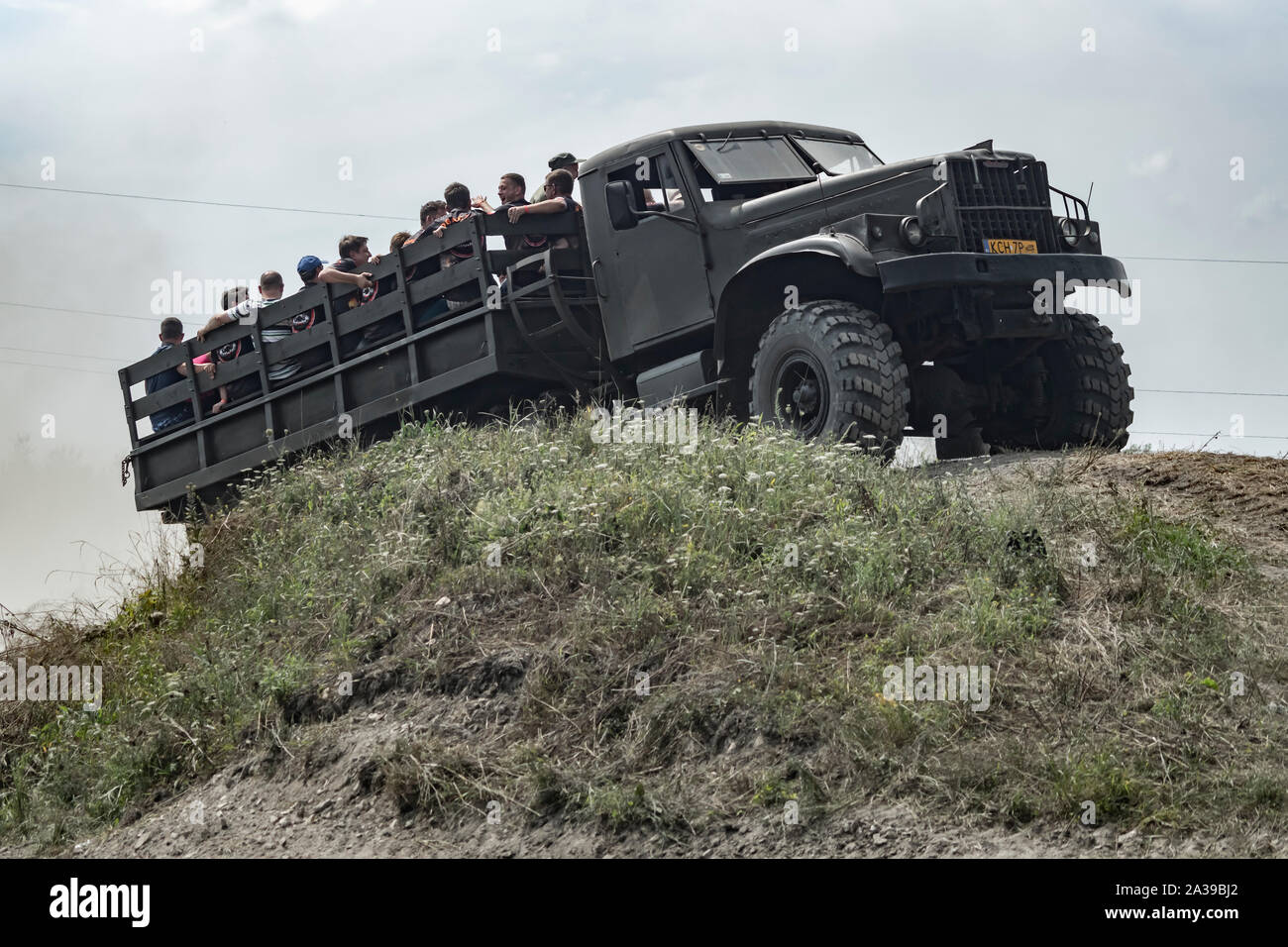 The Soviet heavy utility truck KrAZ-255 6x6 with spectators on the hill ...