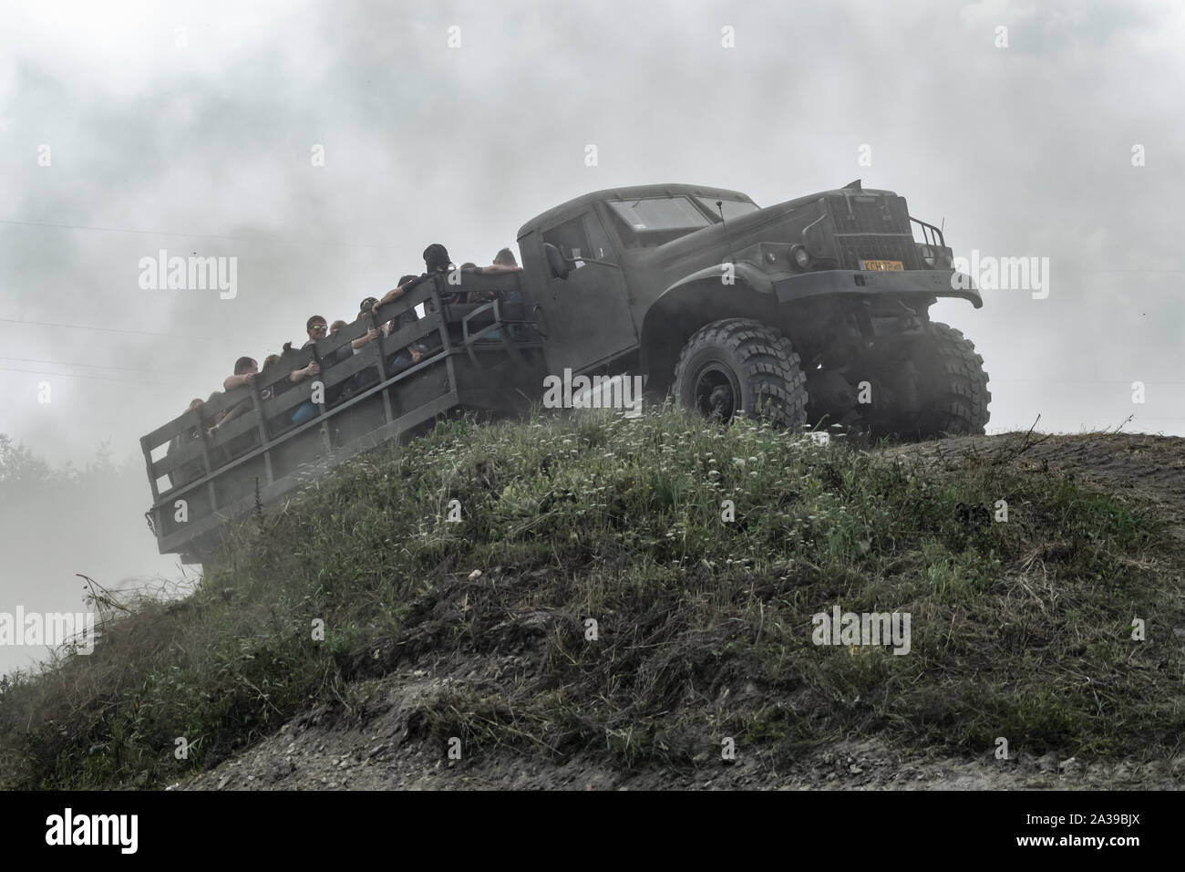 The Soviet heavy utility truck KrAZ-255 6x6 with spectators on the hill ...