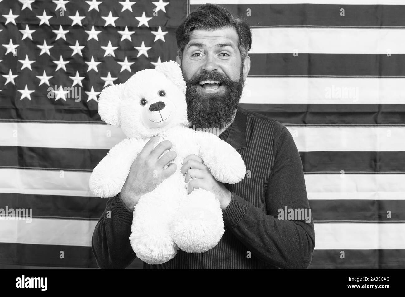 A grand all glory flag. Happy hipster holding teddy bear on american ...