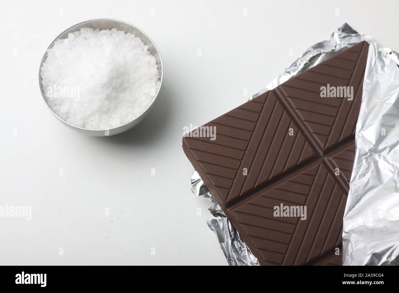 salty chocolate and a bowl of sea salt on white background Stock Photo ...