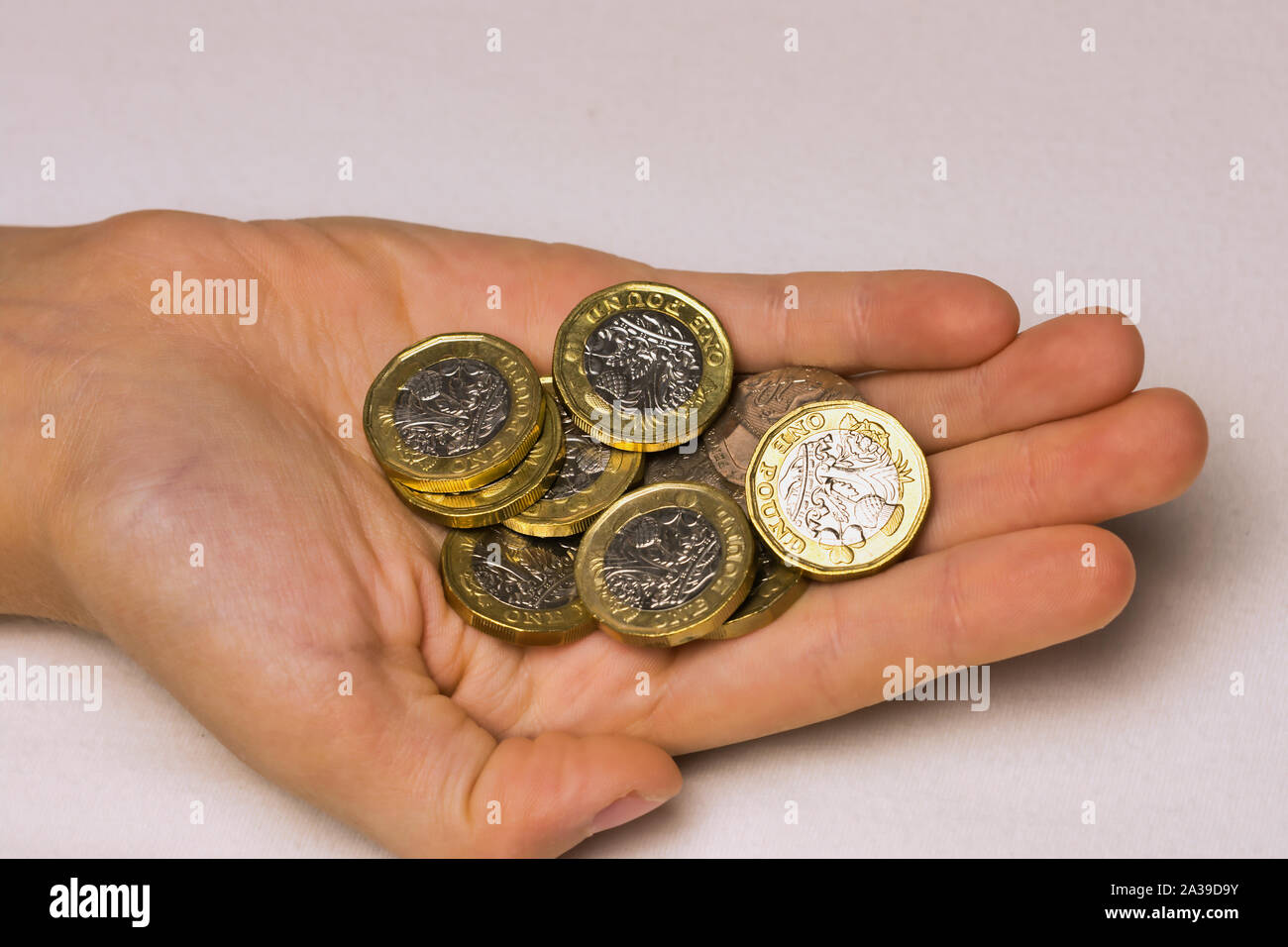 one child hand with British pound coins Stock Photo - Alamy