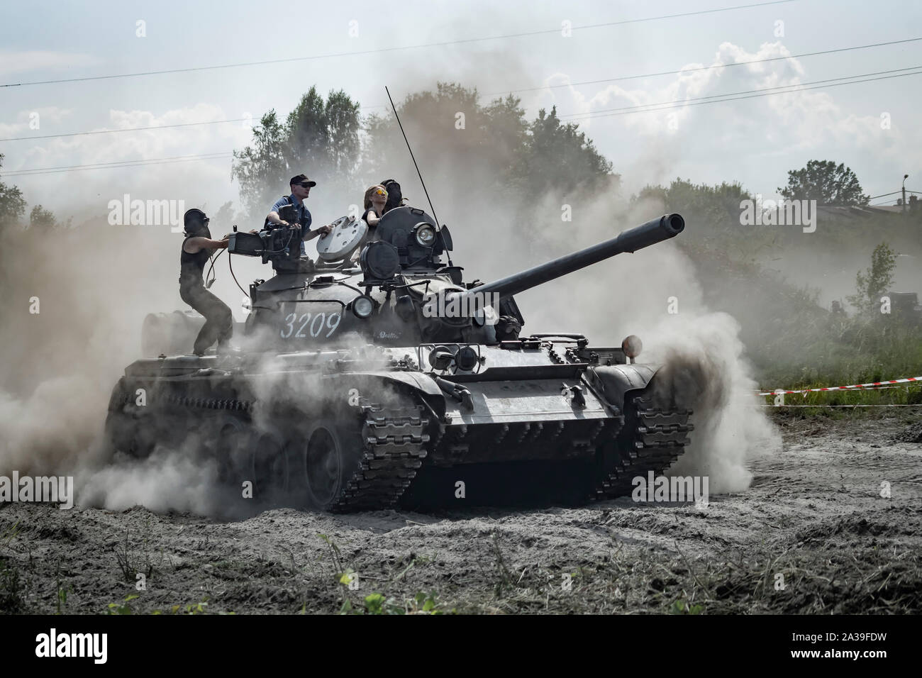 Fast ride in dust of the Soviet T-55 tank with spectators during ...